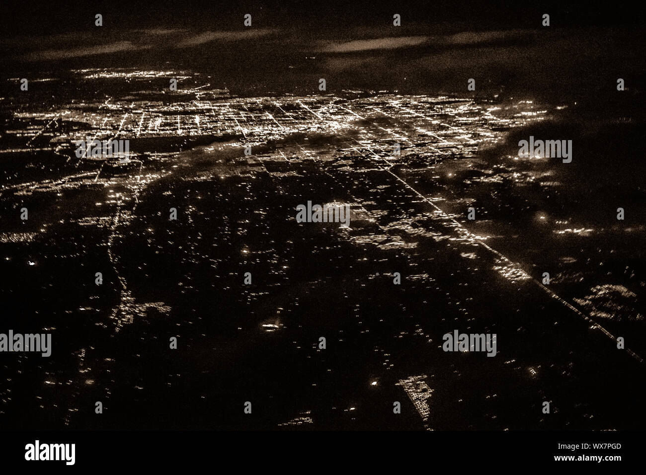 Flying at night over cities below Stock Photo - Alamy