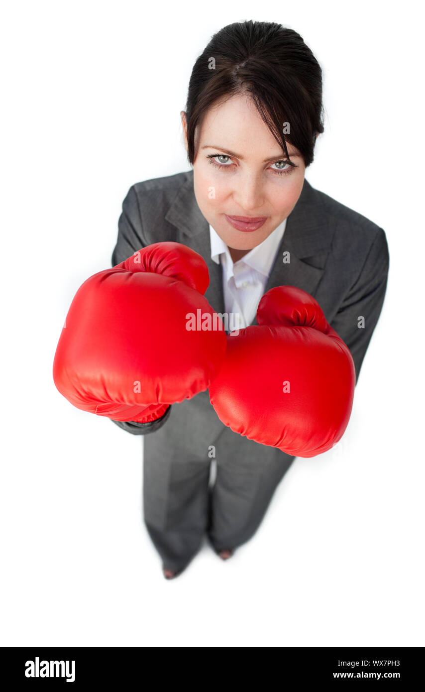 Assertive businesswoman beating the competition against a white ...