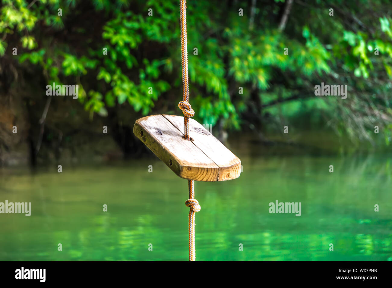 Rope swing child water hi-res stock photography and images - Alamy