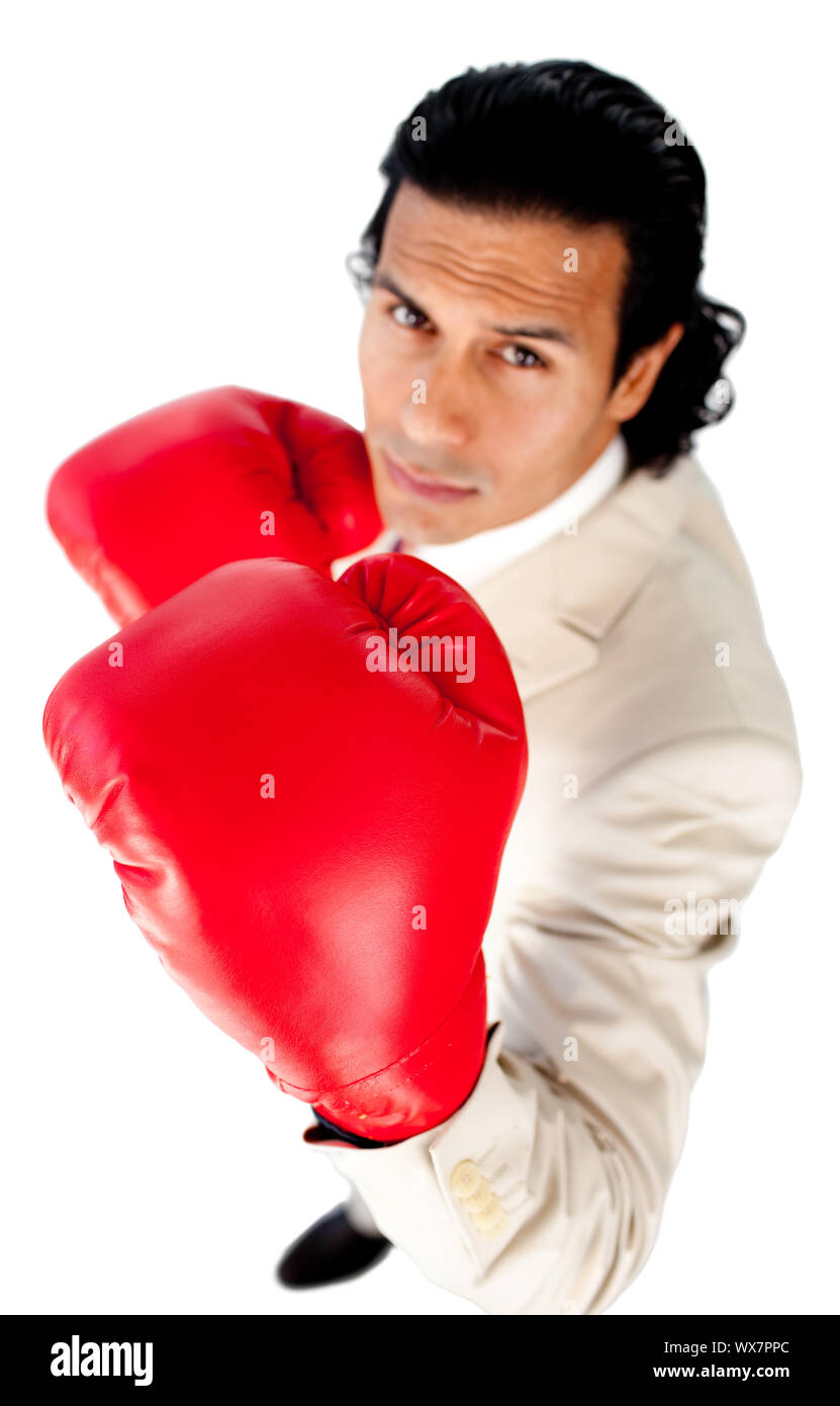 Confident businessman checking out the competition against a white ...