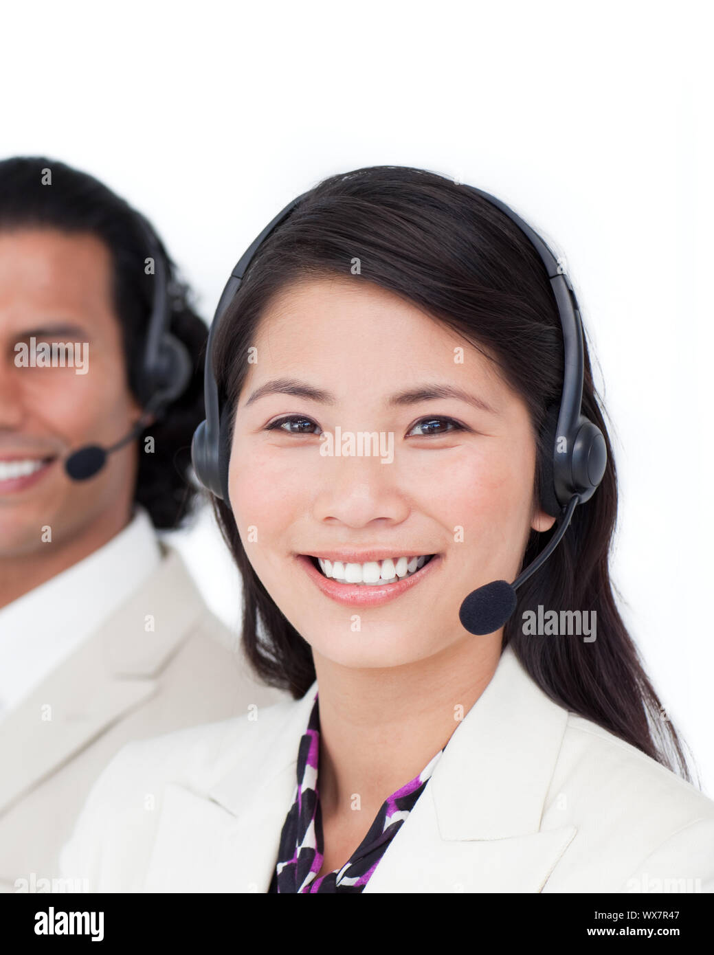 Two customer service agents with headset on against a white background ...