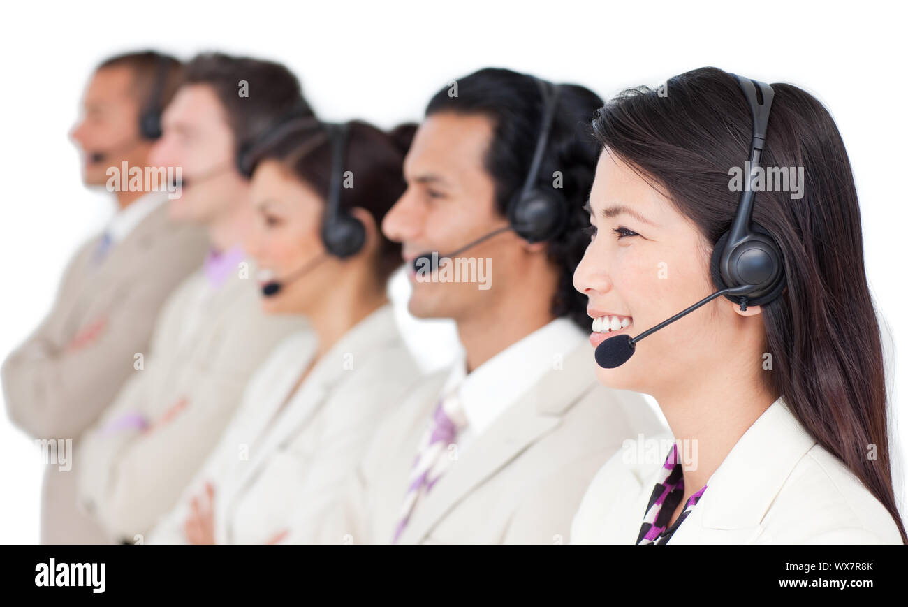 Positive business team with headset on standing in a row against a ...