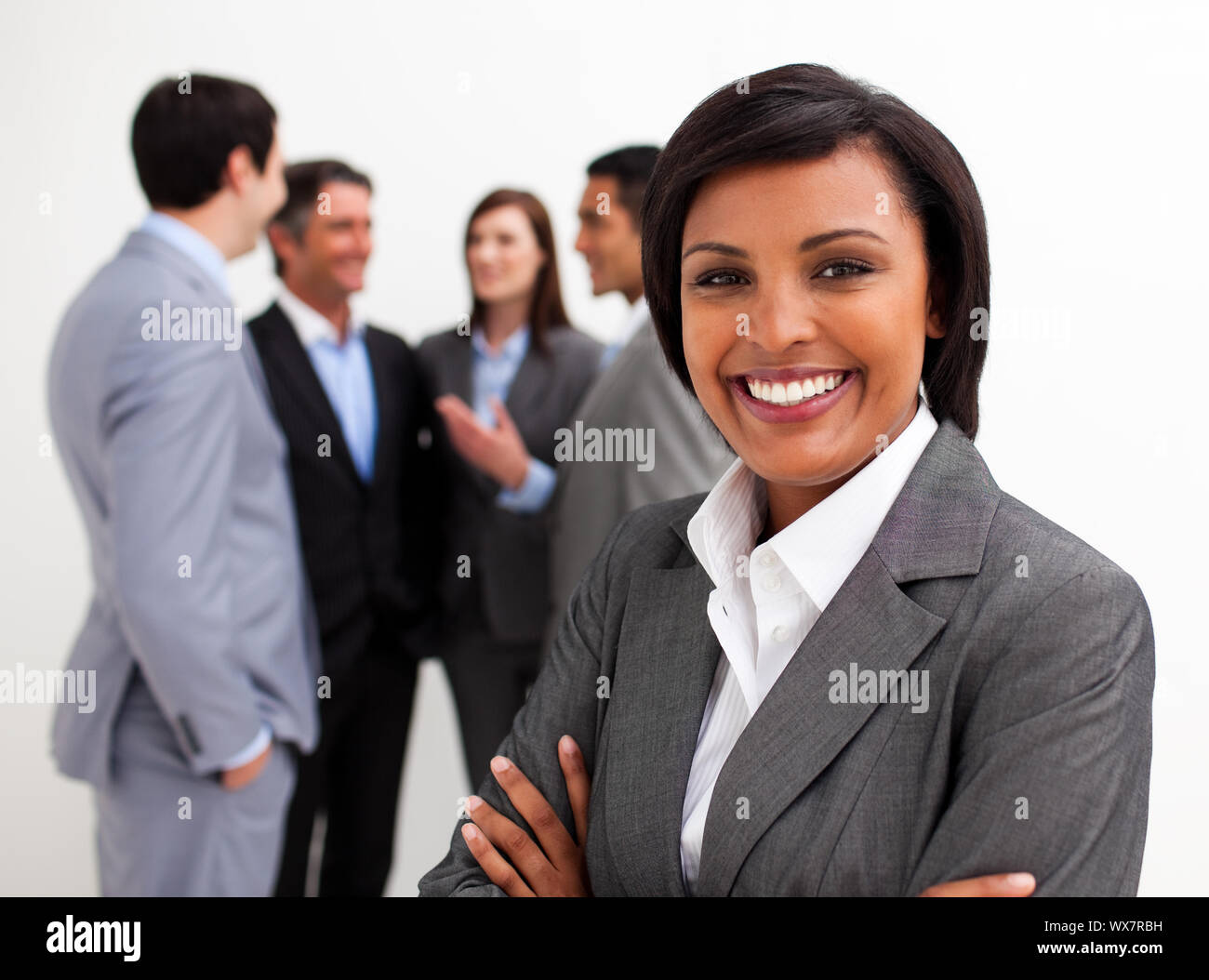 Beautiful businesswoman leading her team agaisnt white background Stock ...
