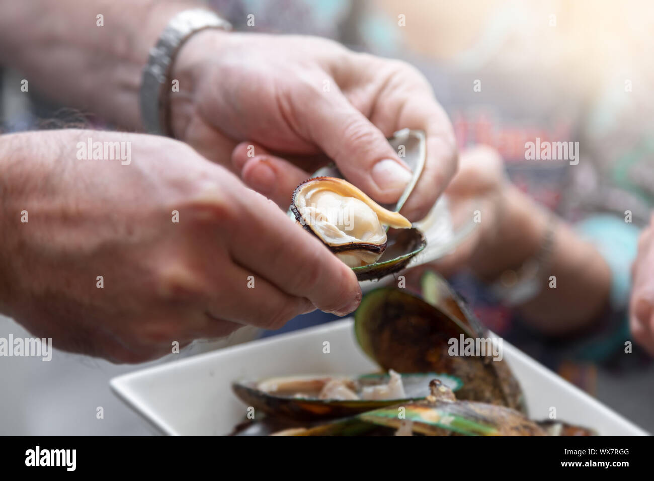 Eating mussel in New Zealand Stock Photo - Alamy