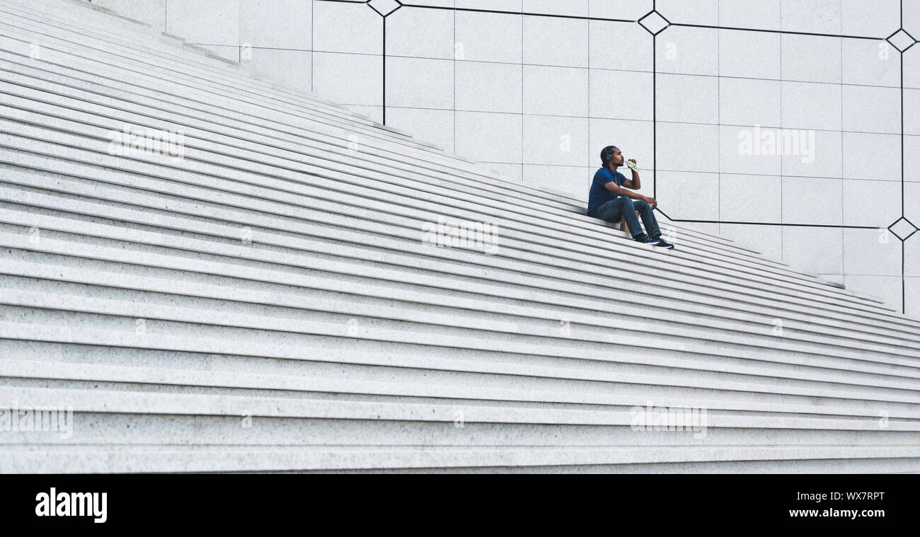 PARIS, FRANCE - 02 OCTOBER 2018: Man taking a rest on white steps Stock ...