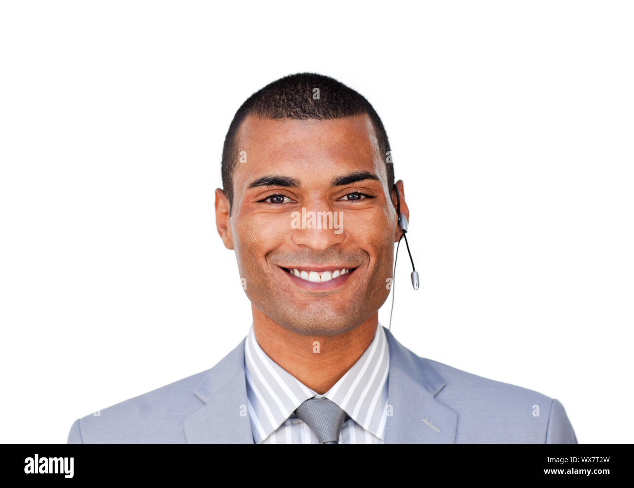 Smiling young customer service agent with headset on against a white ...