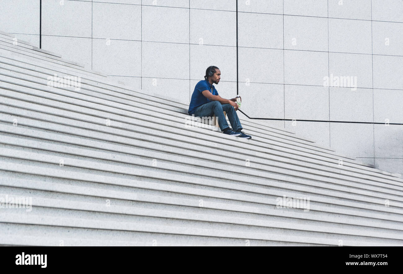 PARIS, FRANCE - 02 OCTOBER 2018: Man taking a rest on white steps Stock ...
