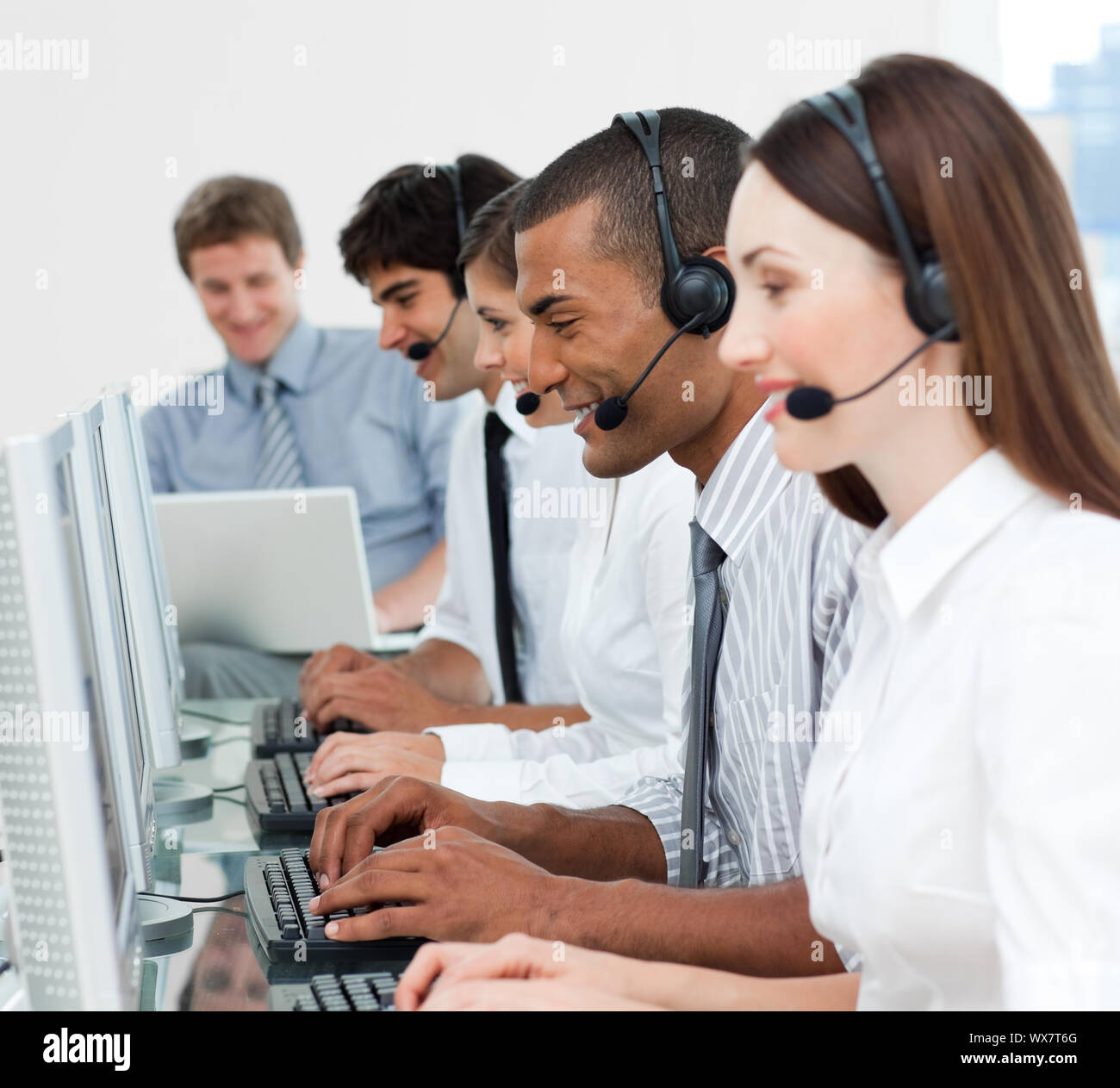 A diverse business group with headset on working in a call center Stock ...