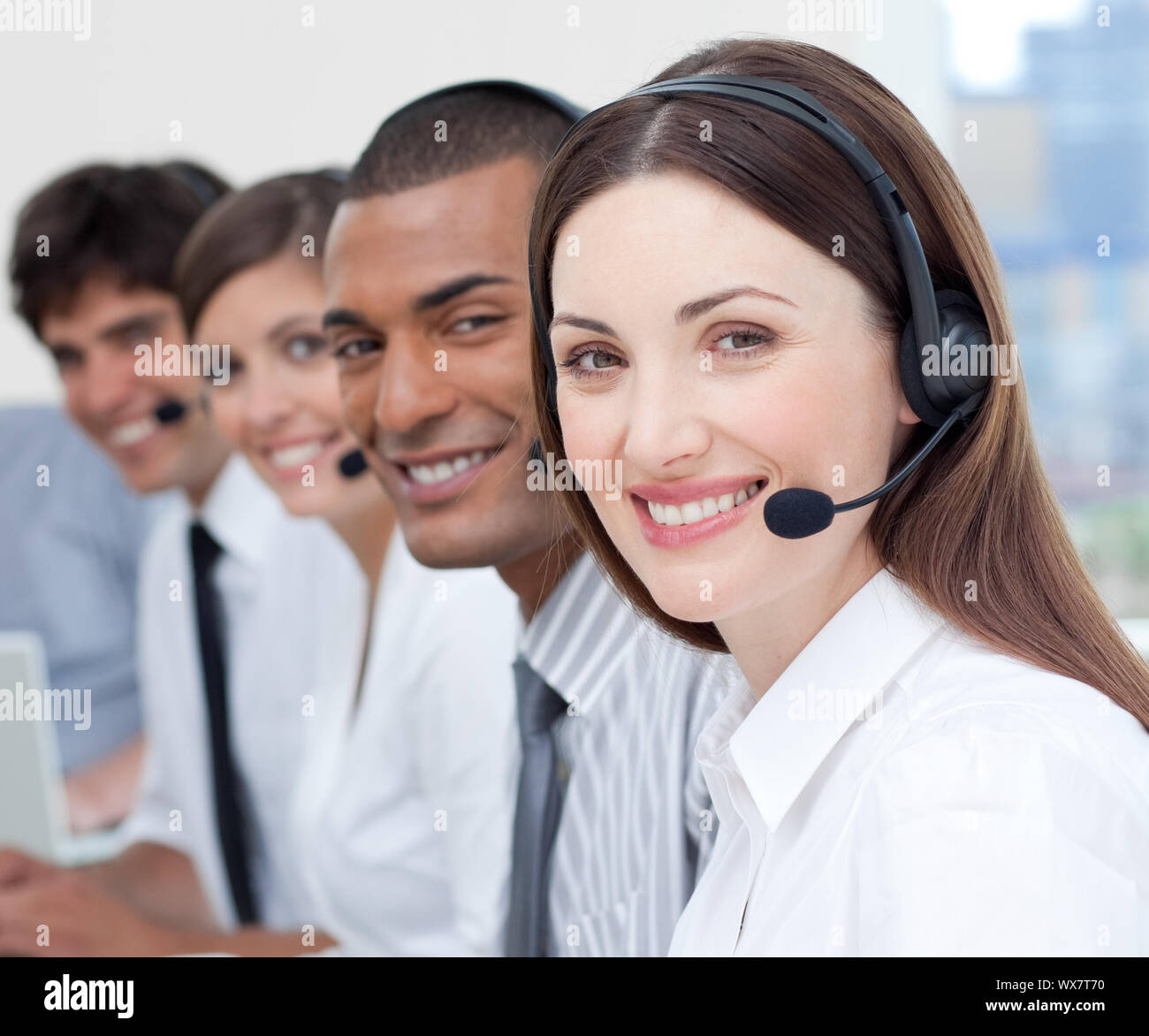 A group of customer service agents showing diversity in a call center ...