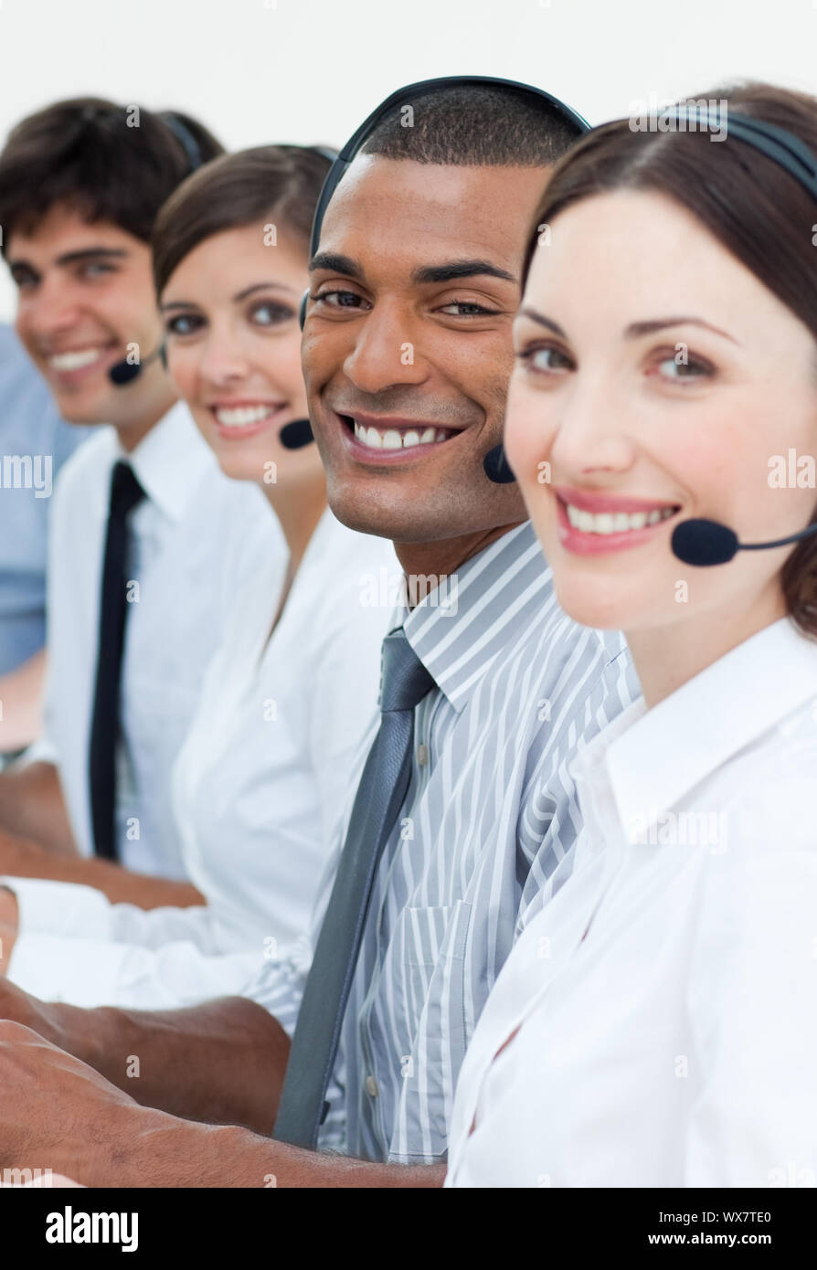 Customer service agents smiling at the camera in a call center Stock ...