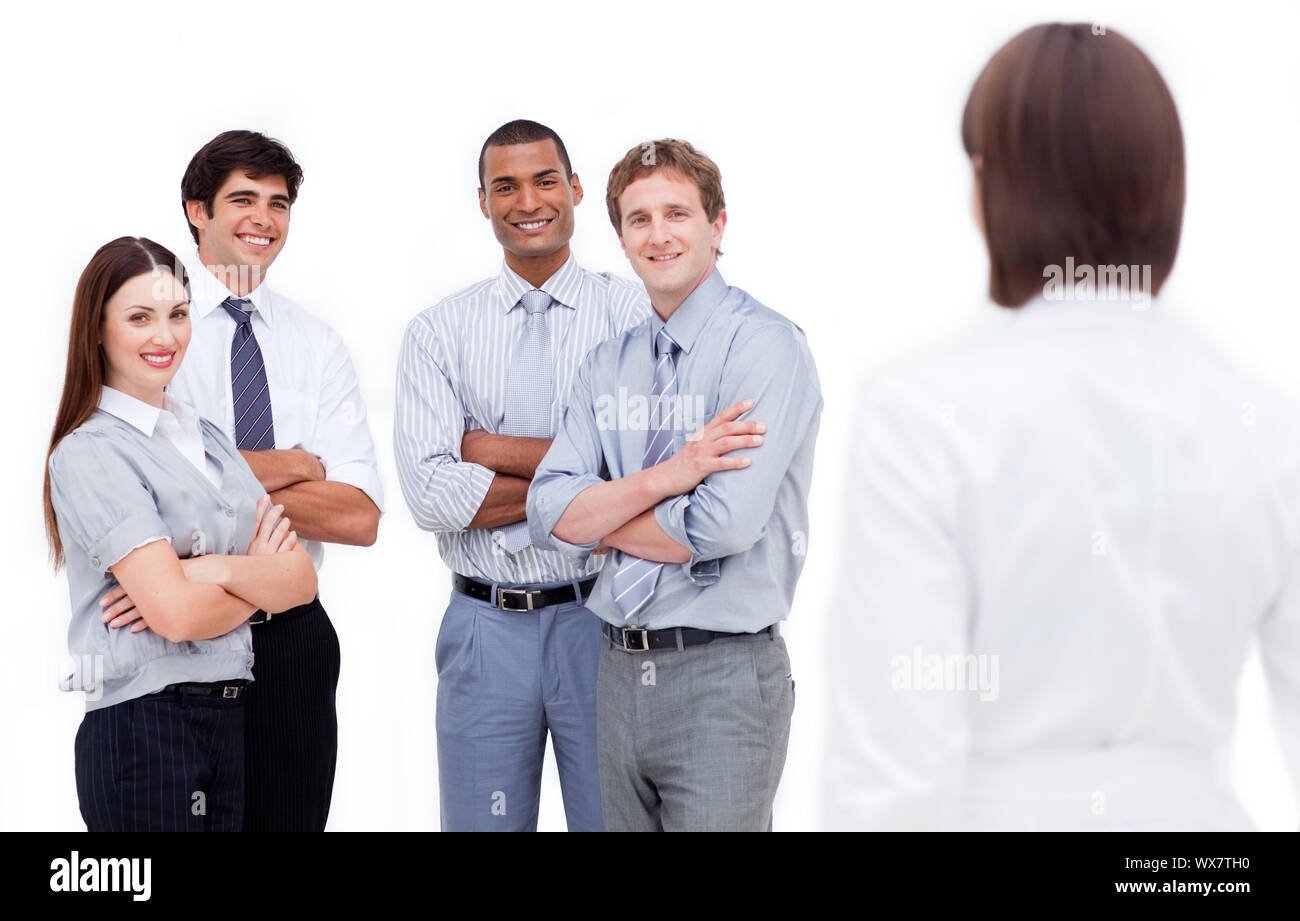 Brunette businesswoman looking back at her colleagues against a white ...