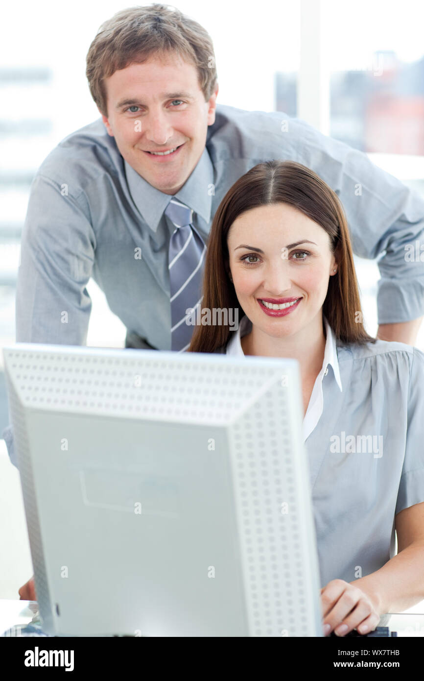 Manager and his employee smiling at the camera in the office Stock ...
