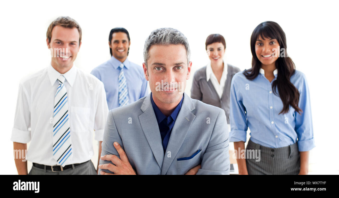 Business partners standing around a table looking at the camera Stock ...