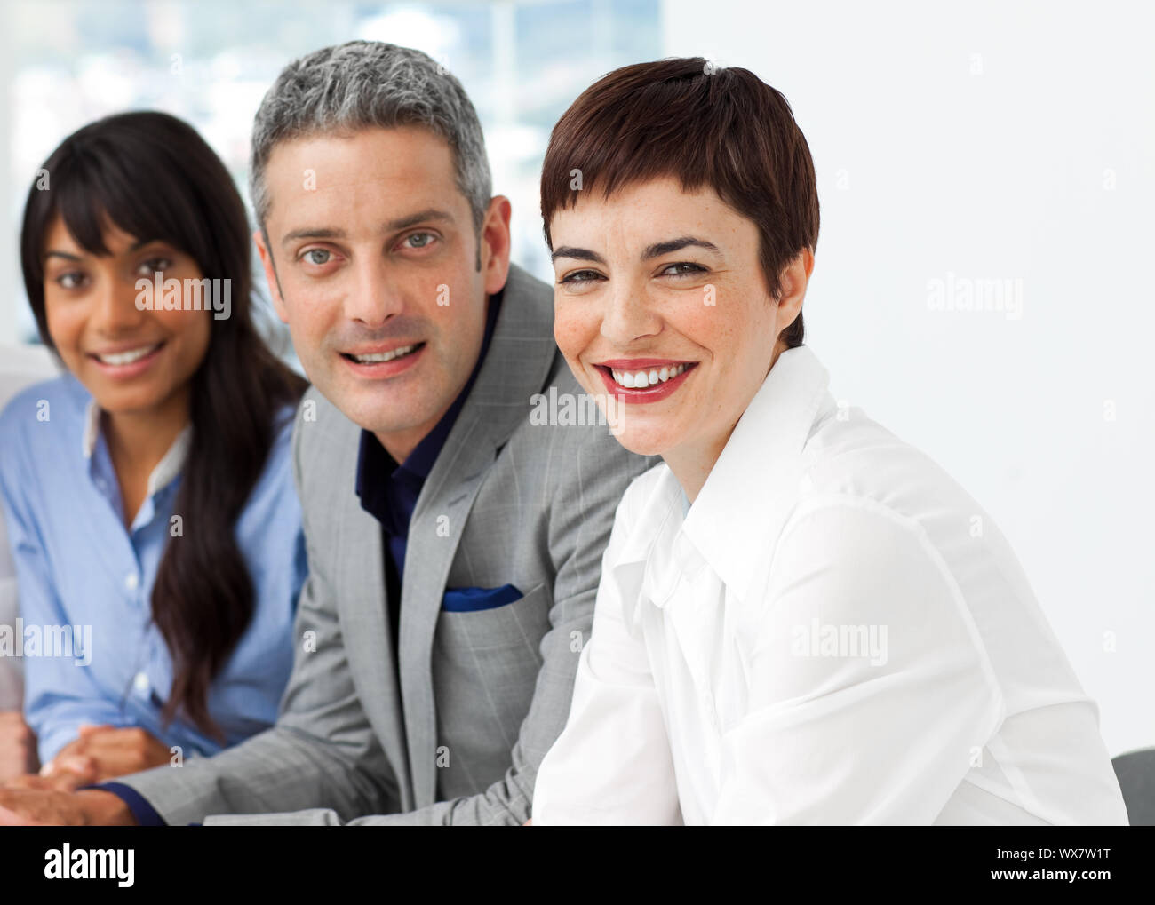 International business people sitting in a row in the office Stock ...