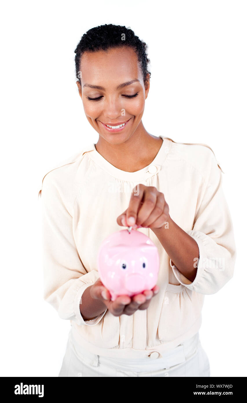 Young Afro-american businesswoman saving money in a piggybank against a ...