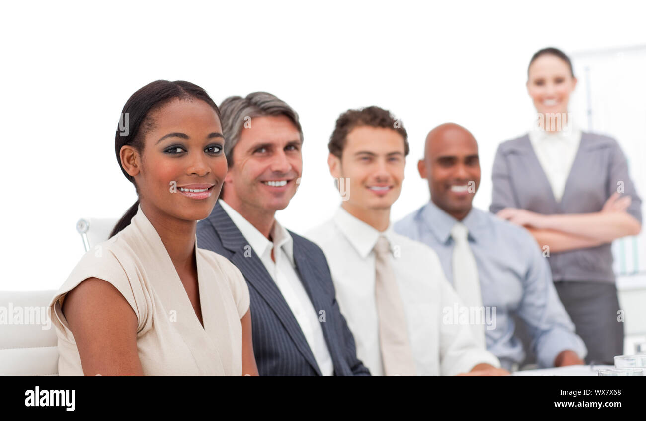 Positive business team smiling at the camera in a meeting Stock Photo ...