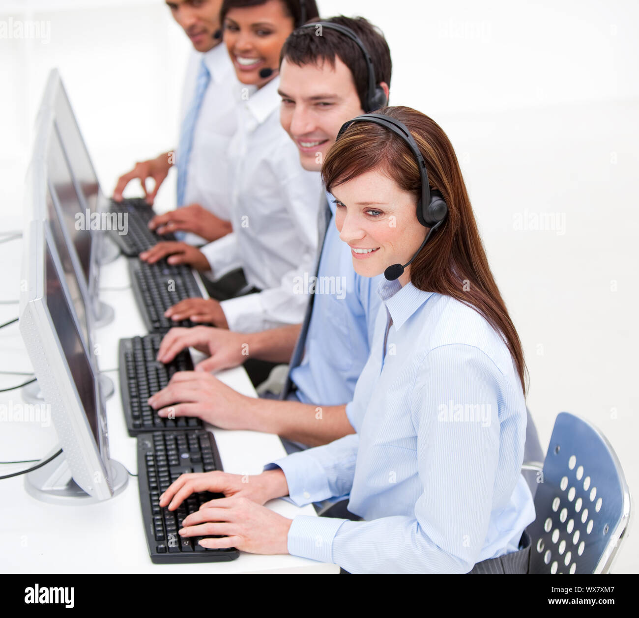 Positive customer service agents at work against a white background ...