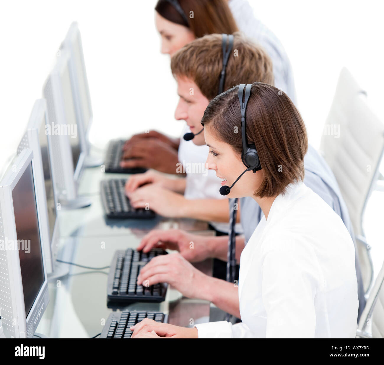 Serious business team working in a call center against a white ...