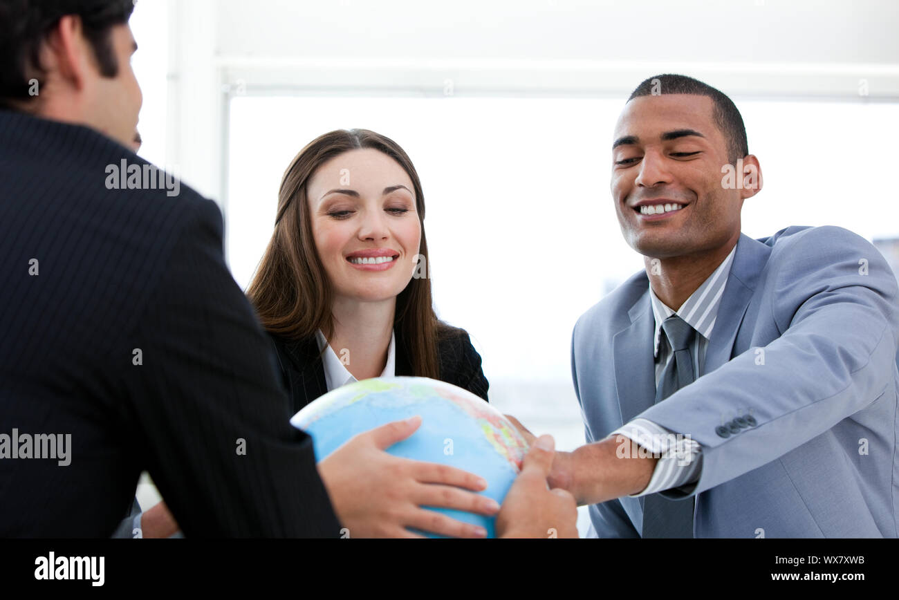 Successful business people having a meeting around a terrestrial globe ...
