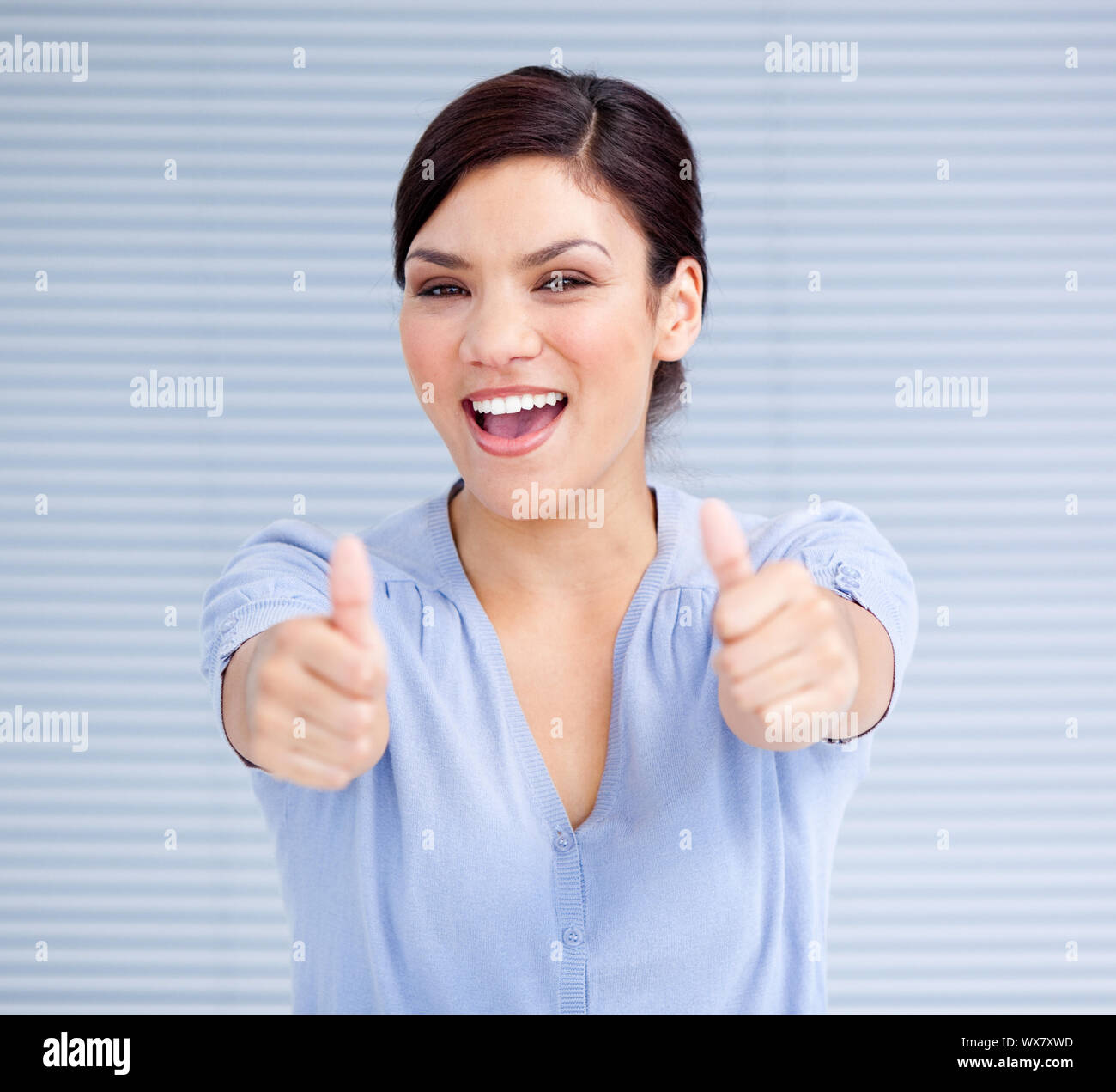 Successful businesswoman with thumbs up at work Stock Photo - Alamy