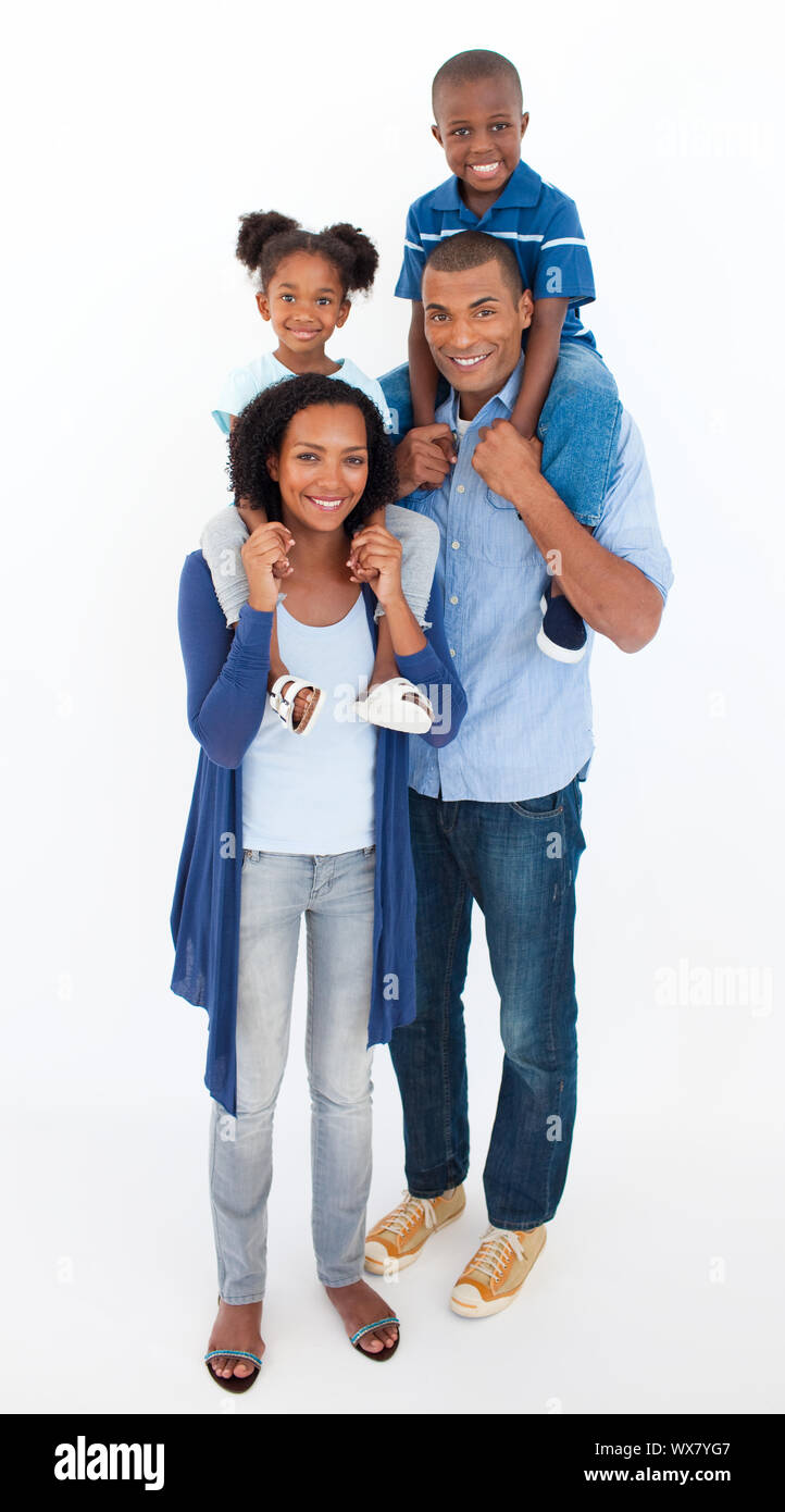 Family giving children piggyback ride against white background Stock ...