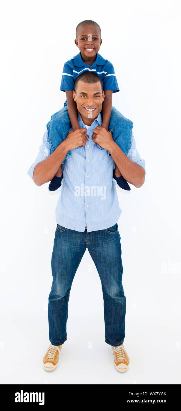 Father giving happy son piggyback ride against white background Stock Photo - Alamy