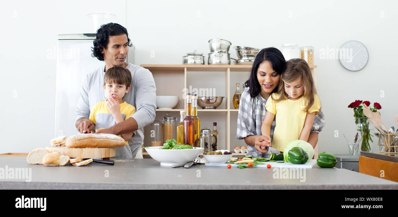 Portrait of a family preparing lunch in the kitchen Stock Photo - Alamy