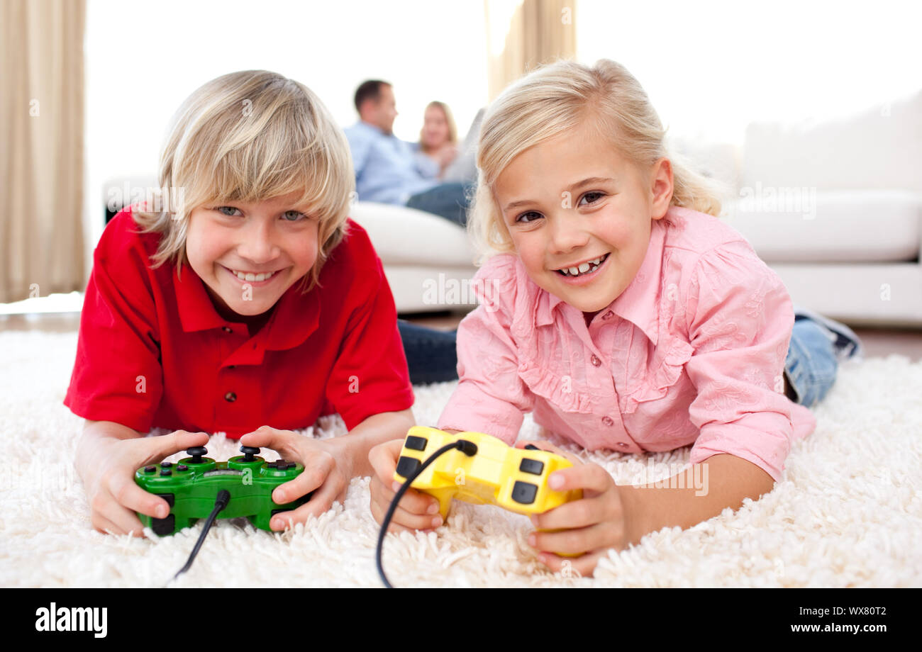 Children playing video games in the living-room Stock Photo - Alamy