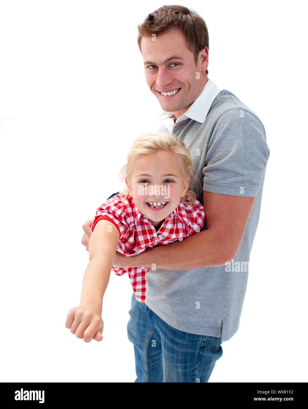 Cute little girl enjoying piggyback ride with her father against a ...