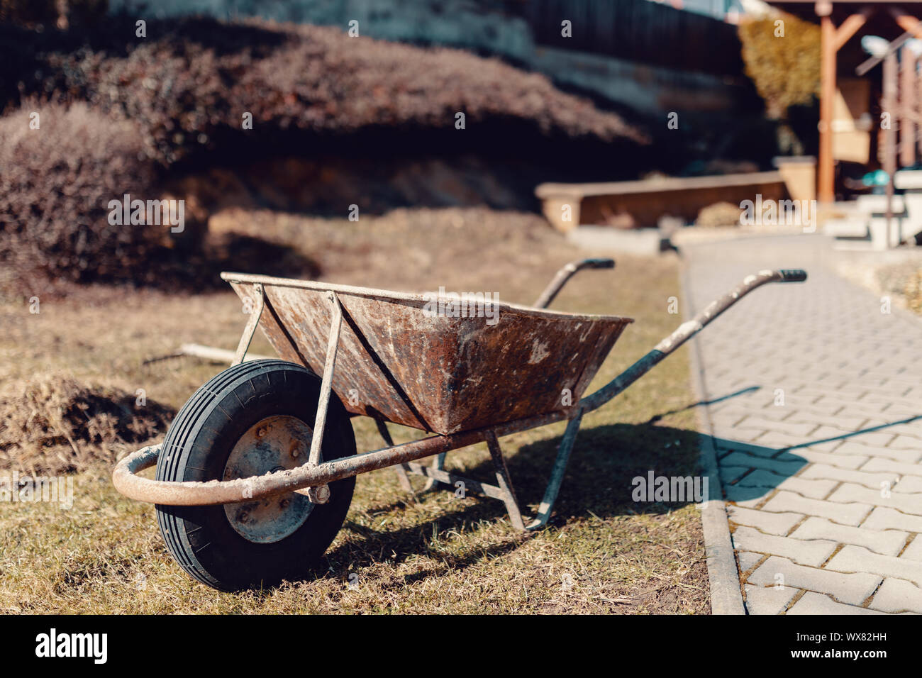 old rusty garden wheelbarrow Stock Photo - Alamy