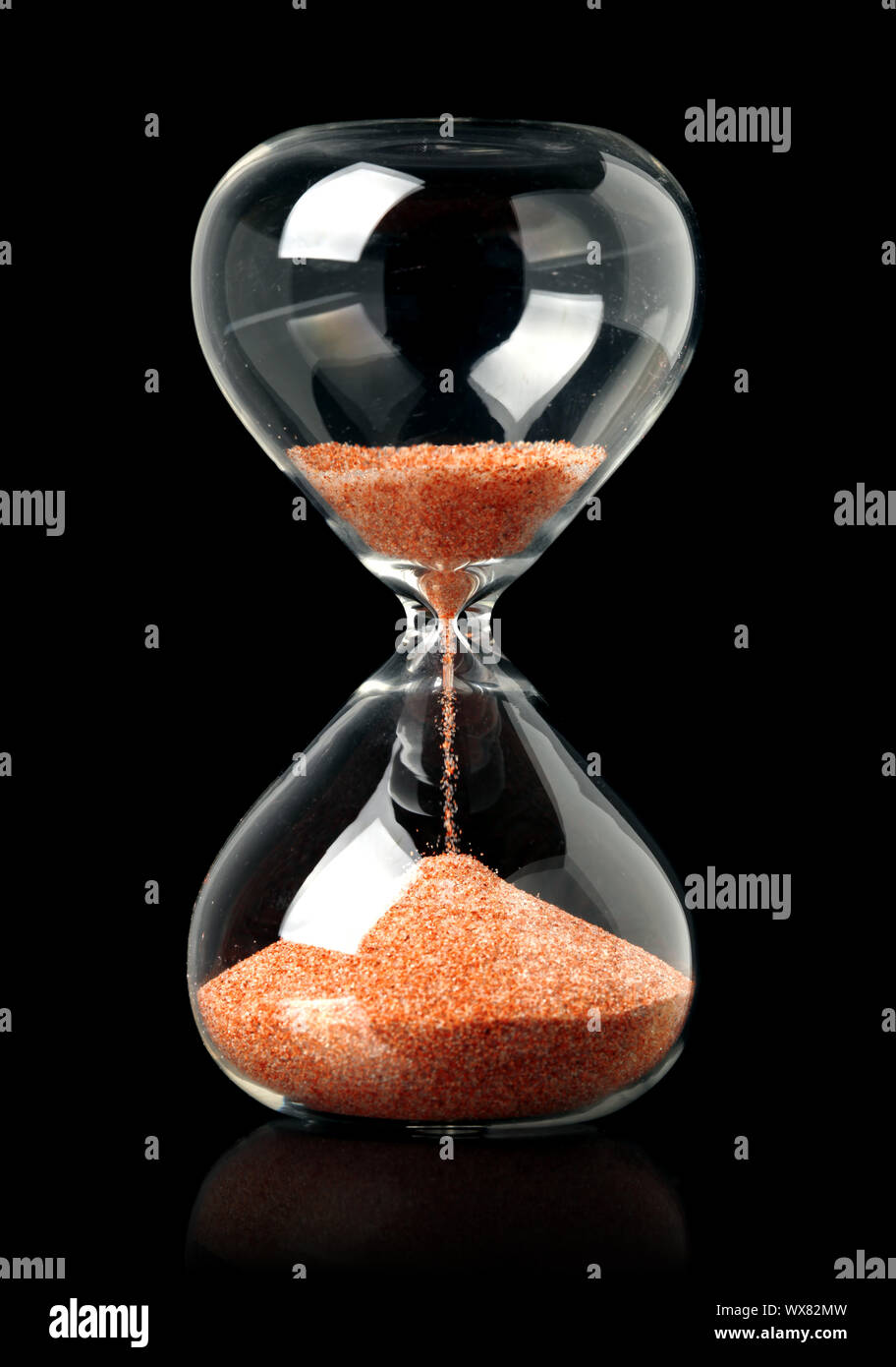 Hourglass with red sand showing the passage of time Stock Photo - Alamy