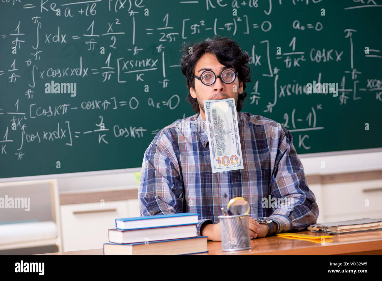 Funny male math teacher in the classroom Stock Photo - Alamy