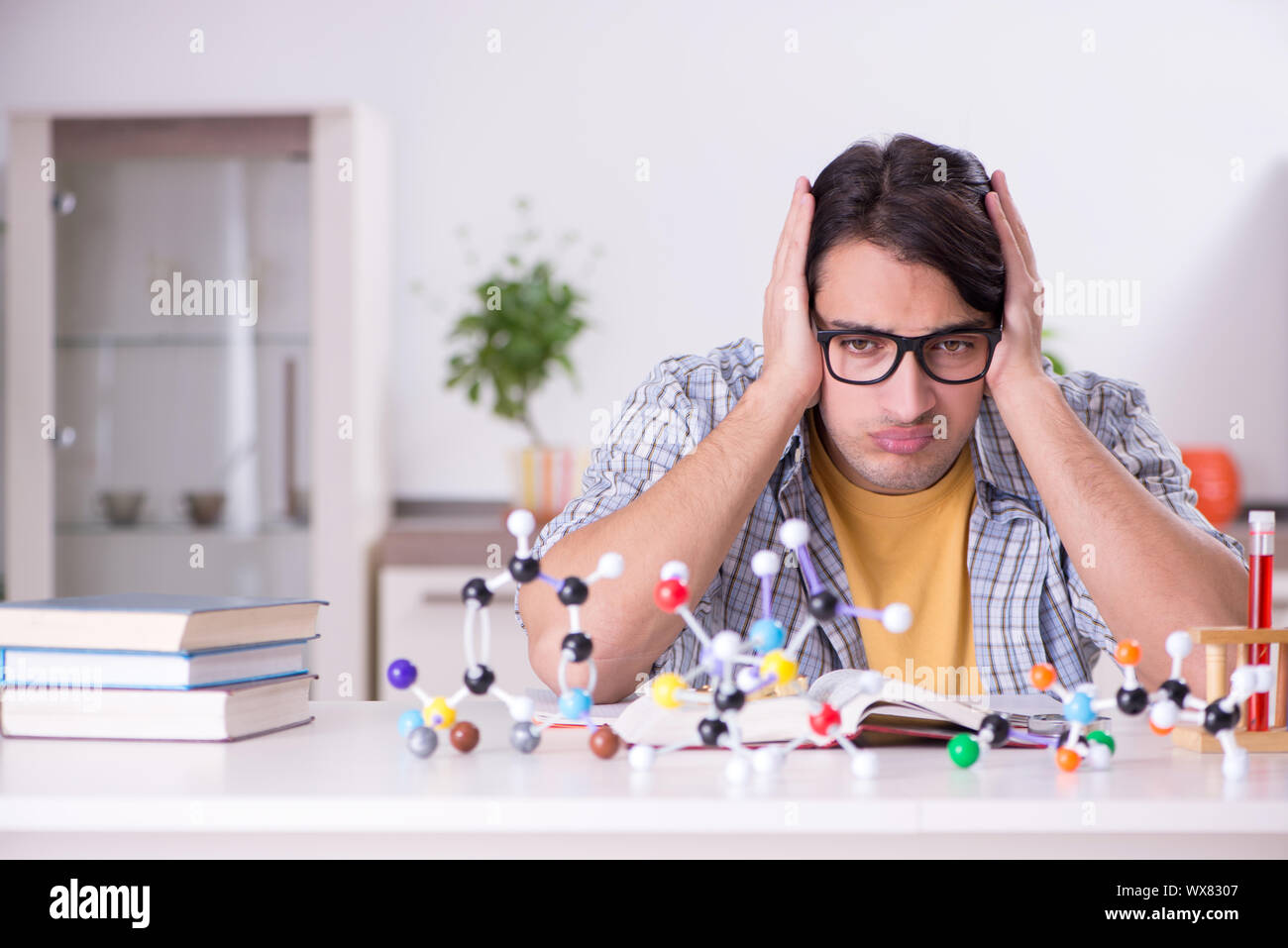 Young student physicist preparing for exam at home Stock Photo - Alamy