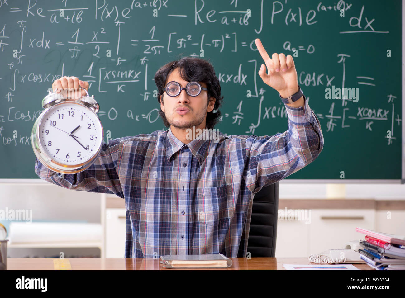 Funny male math teacher in the classroom Stock Photo - Alamy
