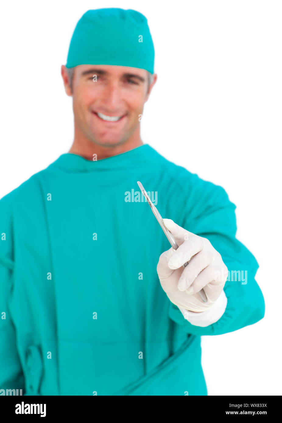 Assertive surgeon holding a scalpel against a white background Stock ...