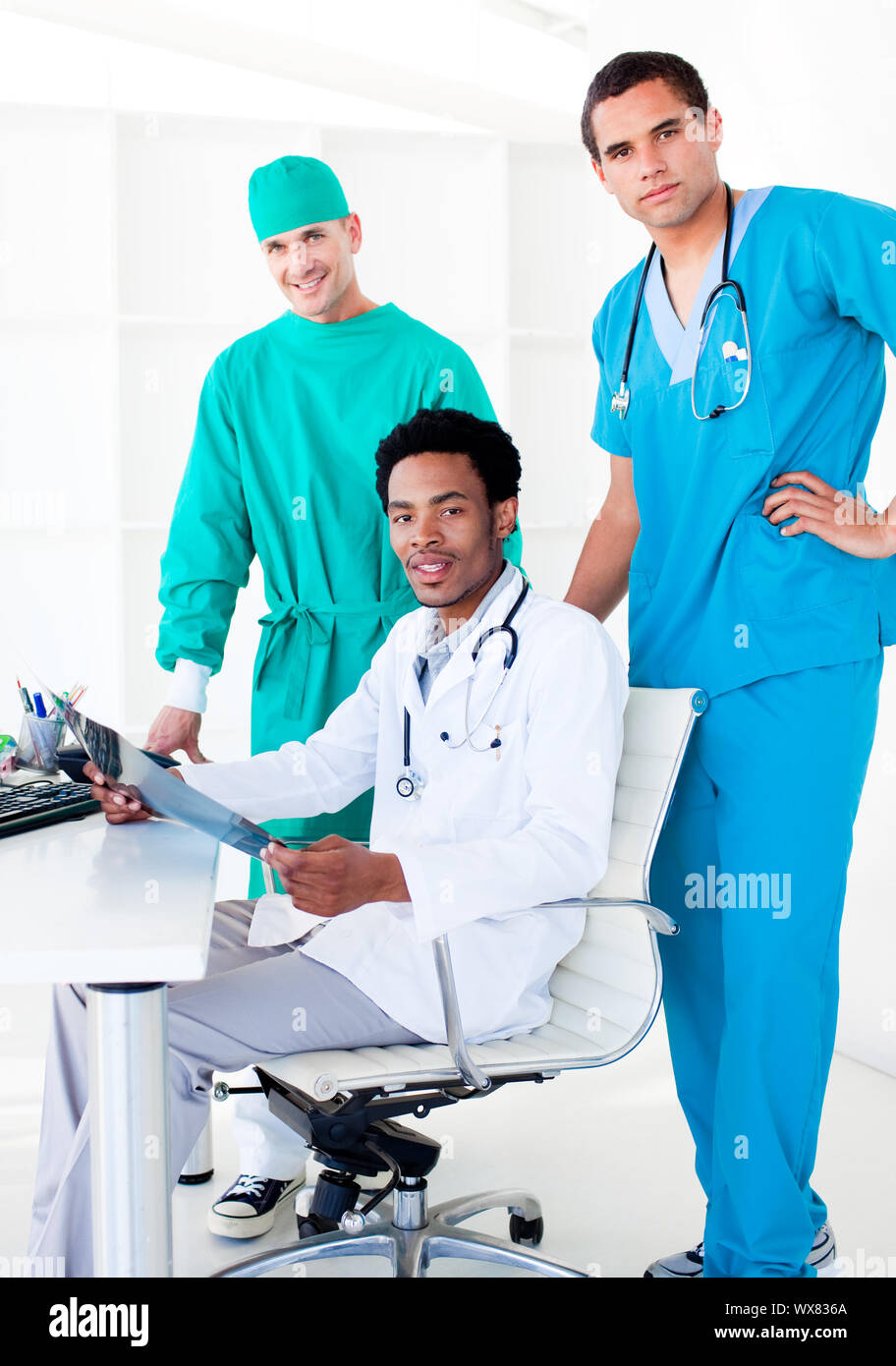 Assertive male doctors looking at X-Ray in hospital Stock Photo - Alamy