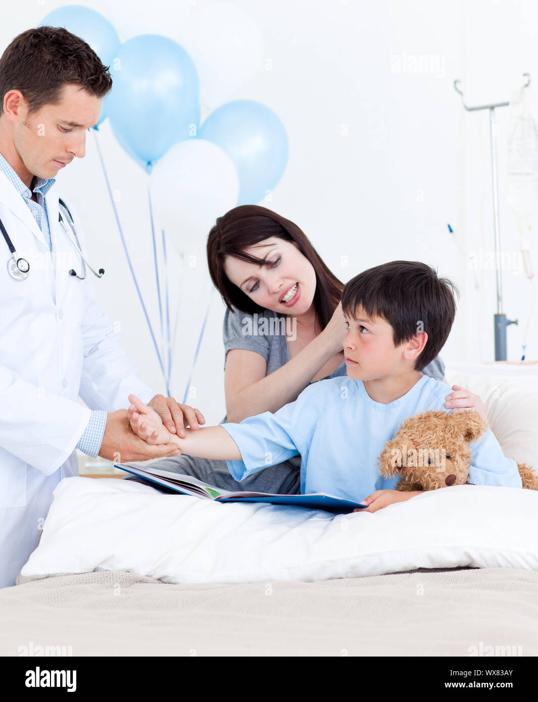 Male doctor comforting patients bed hi-res stock photography and images ...