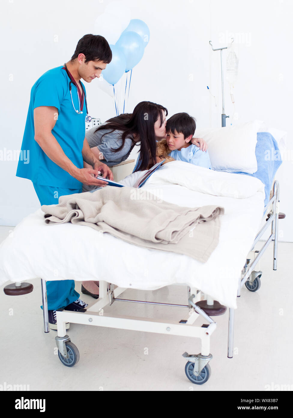 Affectionate woman kissing his sick son at the hospital Stock Photo - Alamy