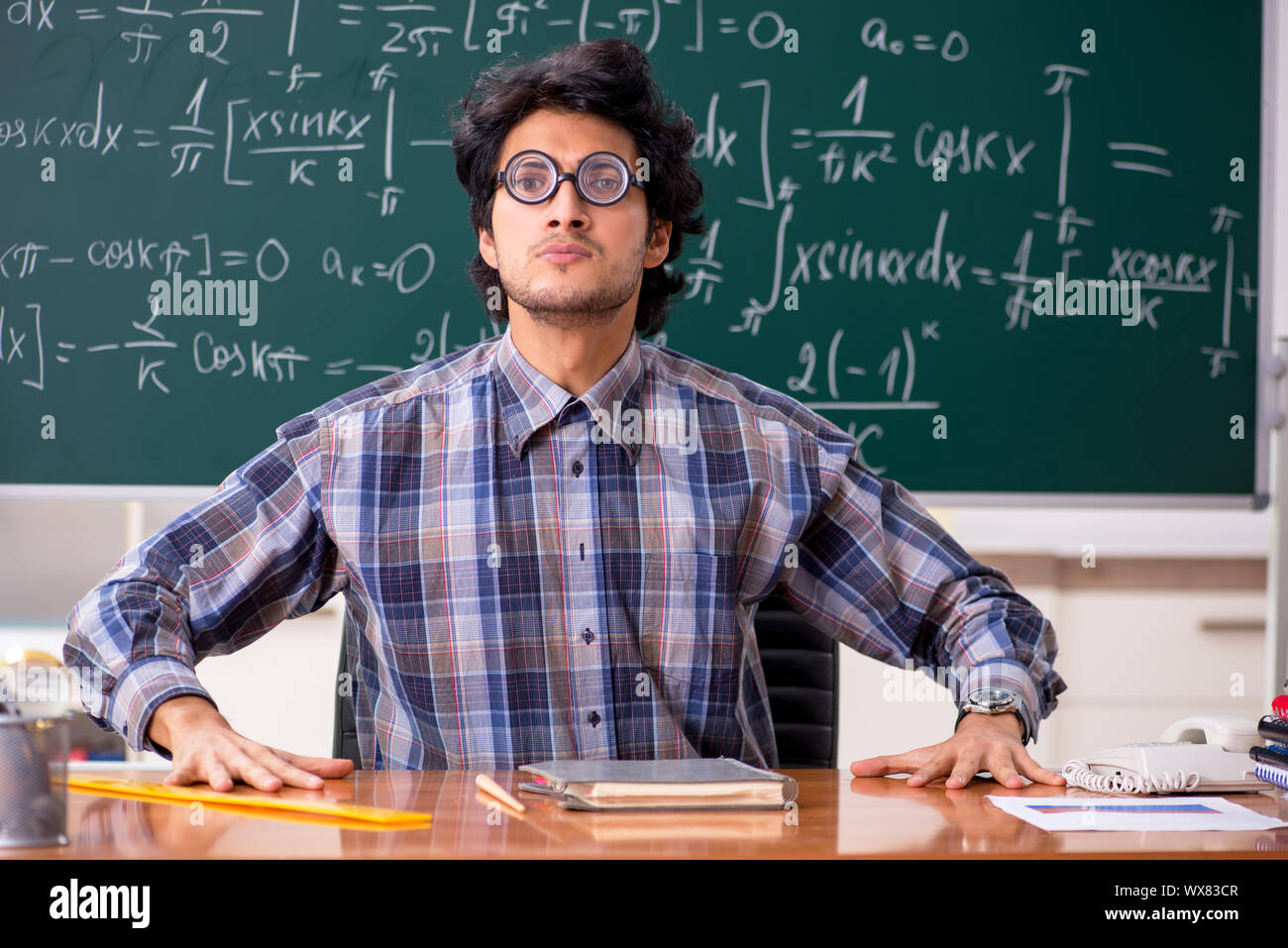 Funny male math teacher in the classroom Stock Photo - Alamy