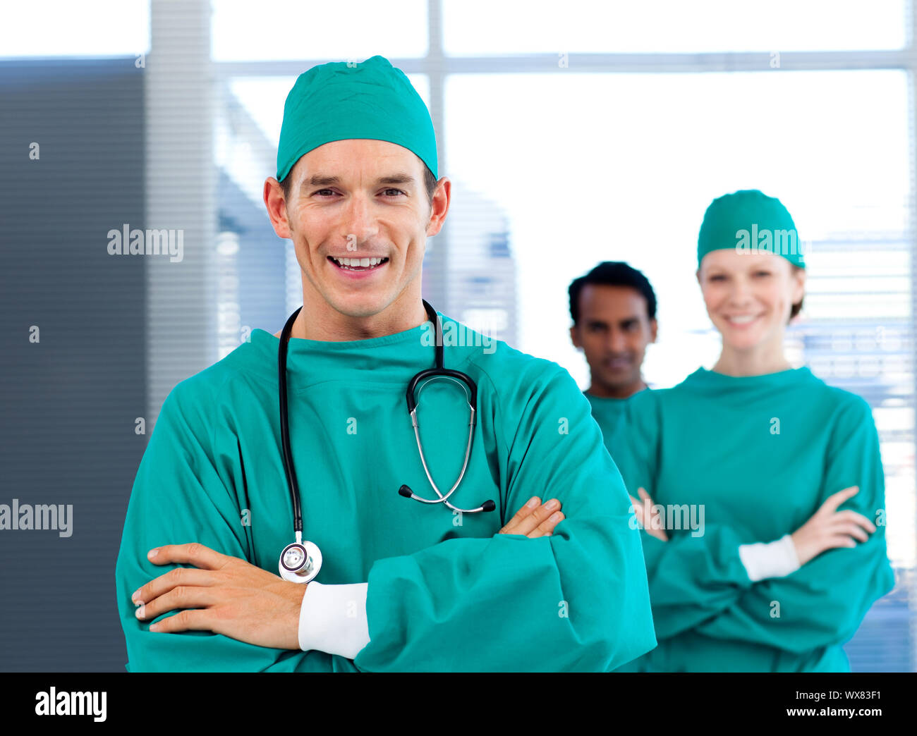 A diverse group of surgeon smiling at the camera in a hospital Stock ...