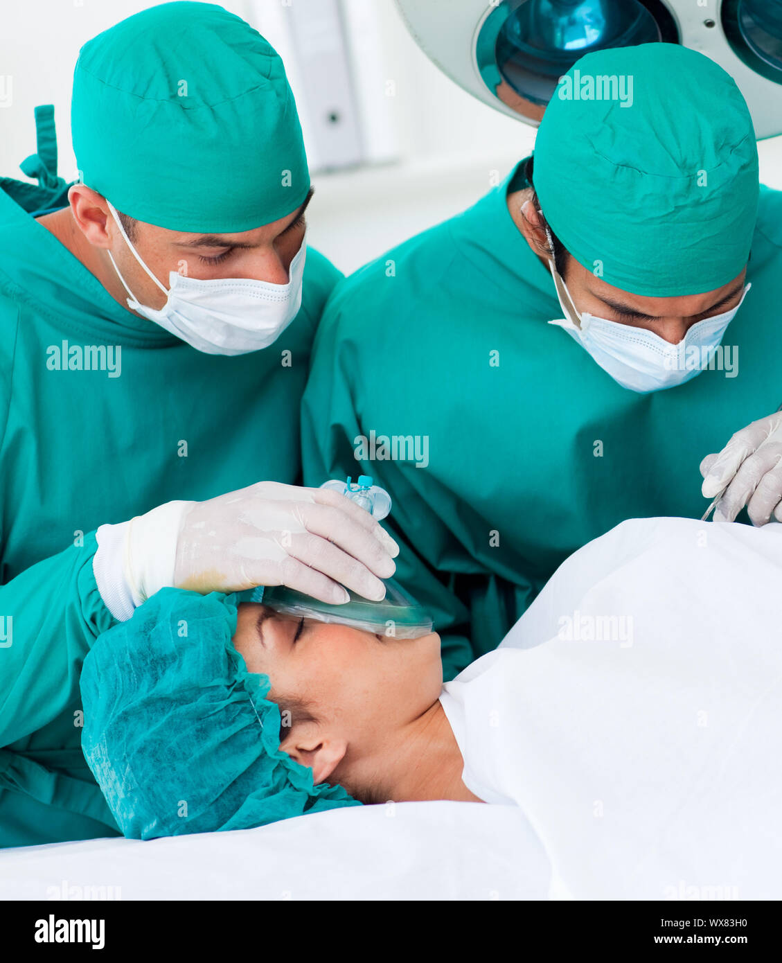 Close-up of surgeons near patient lying on operating table in the ...