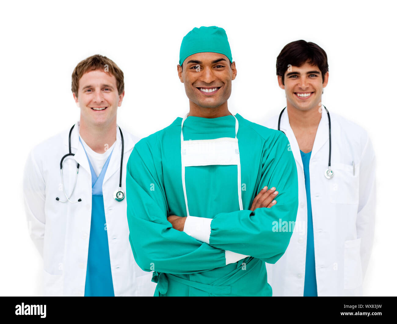 Medical team smiling at the camera against white background Stock Photo ...