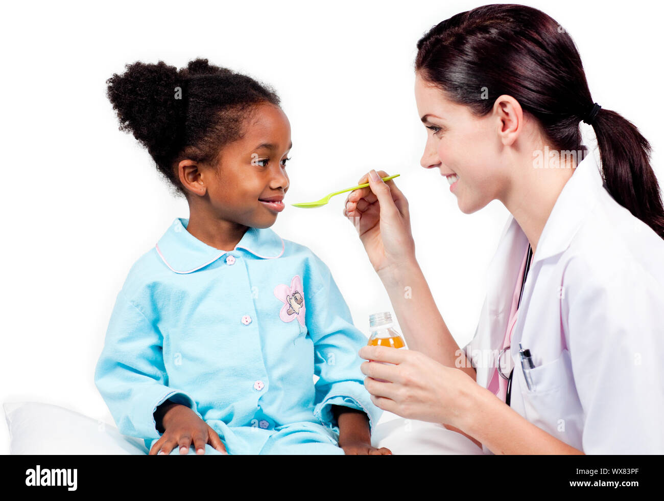 Adorable little girl taking medicine against a white background Stock ...