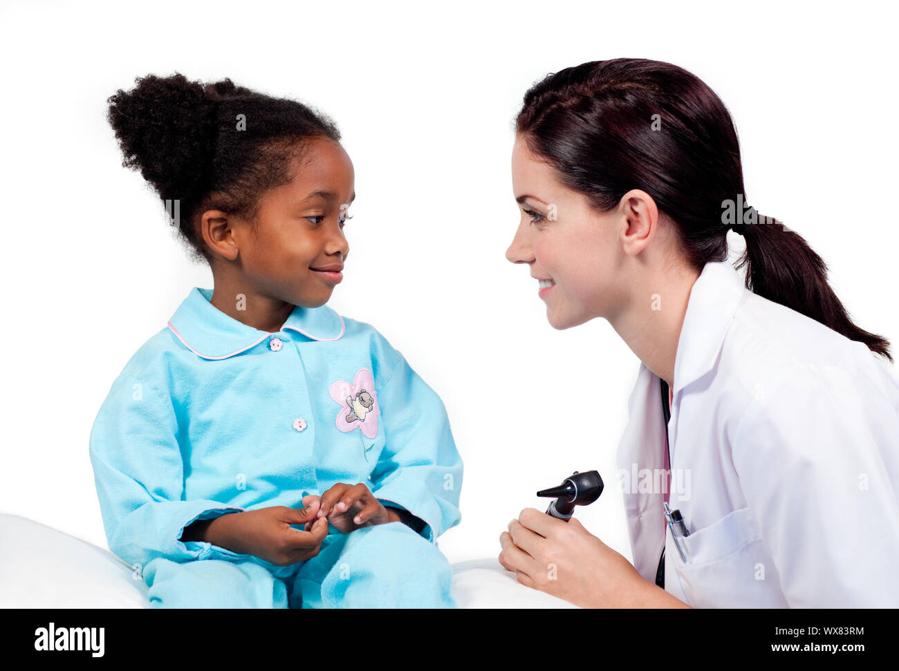 Adorable little girl attending medical check-up isolated on a white ...