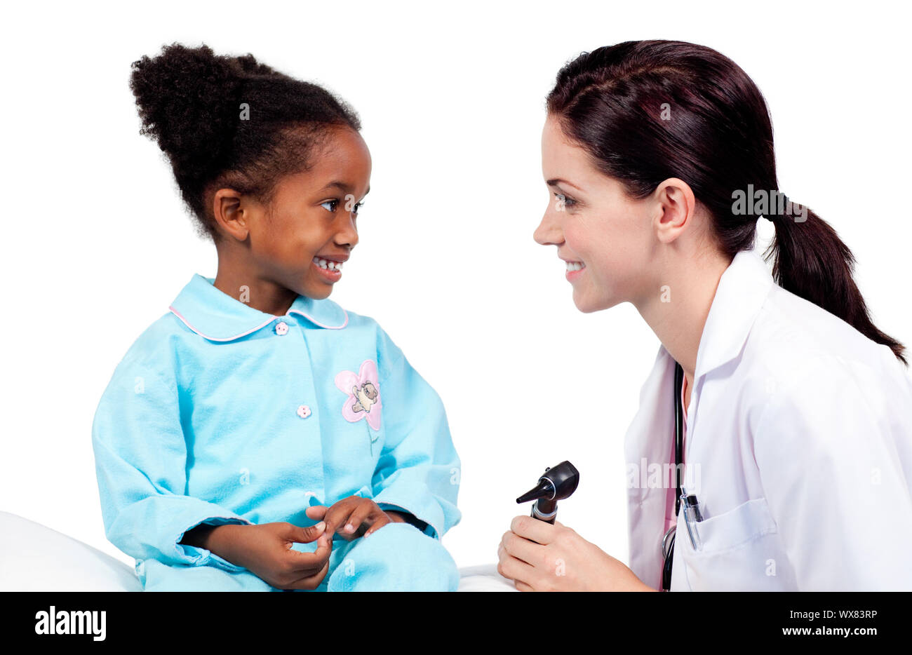 Smiling little girl attending medical check-up isolated on a white ...