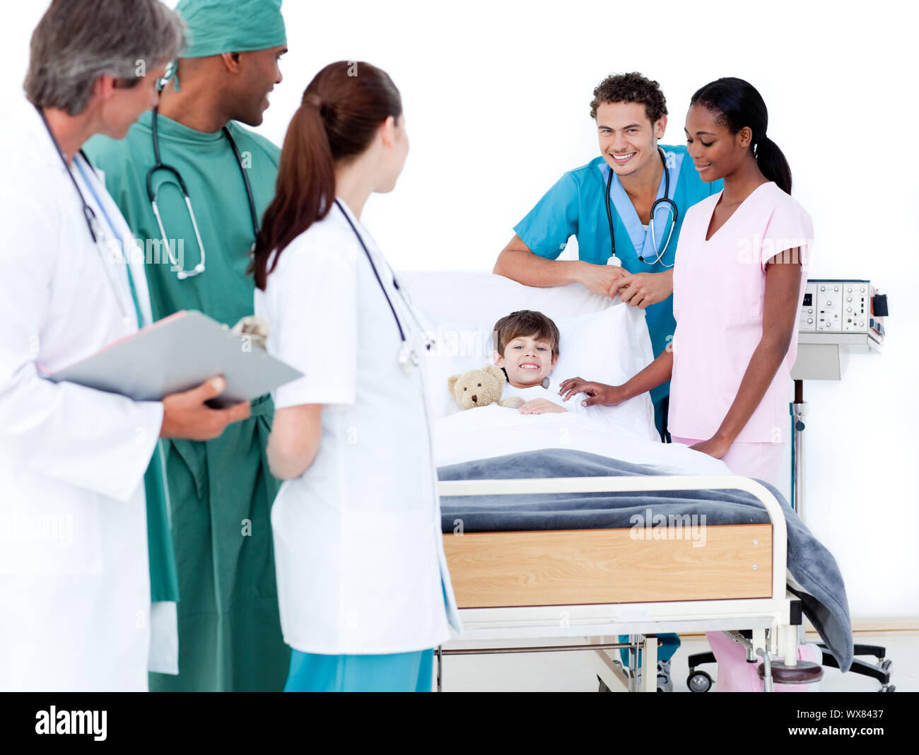 Positive medical team taking care of a little boy in the hospital Stock ...
