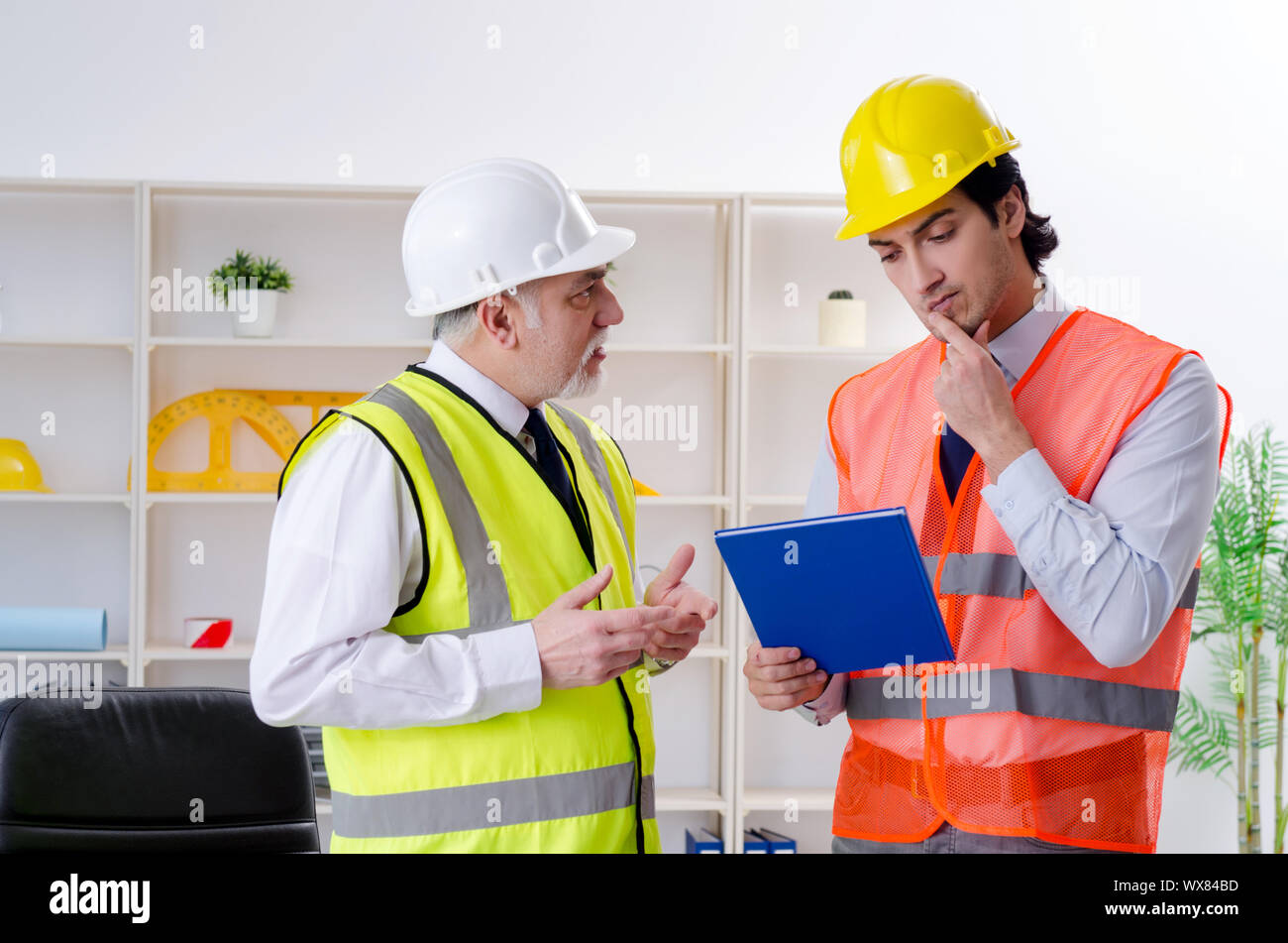 Two engineers colleagues working under project Stock Photo - Alamy
