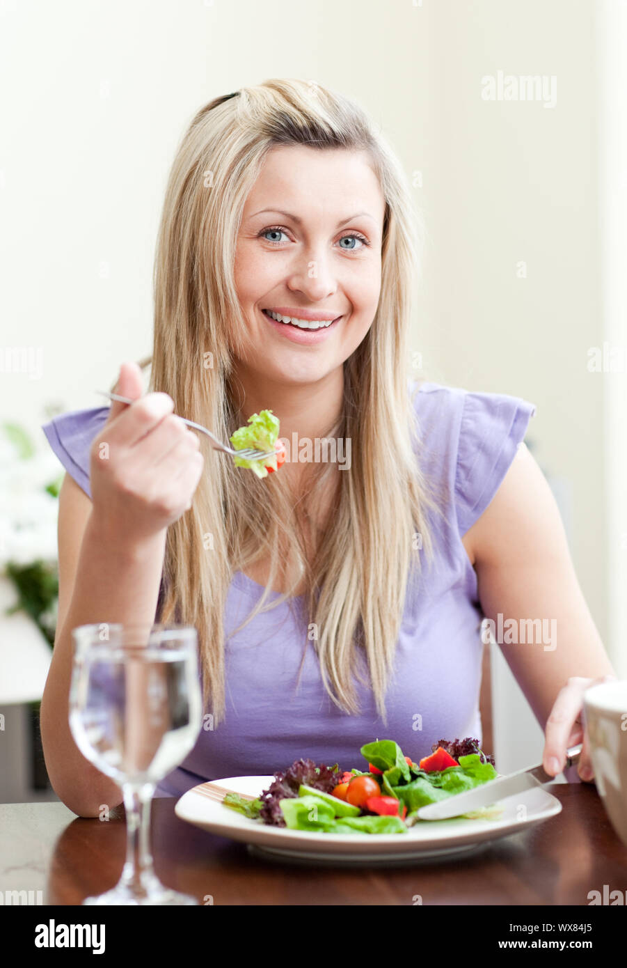 Cute woman having an healthy dinner at home Stock Photo - Alamy