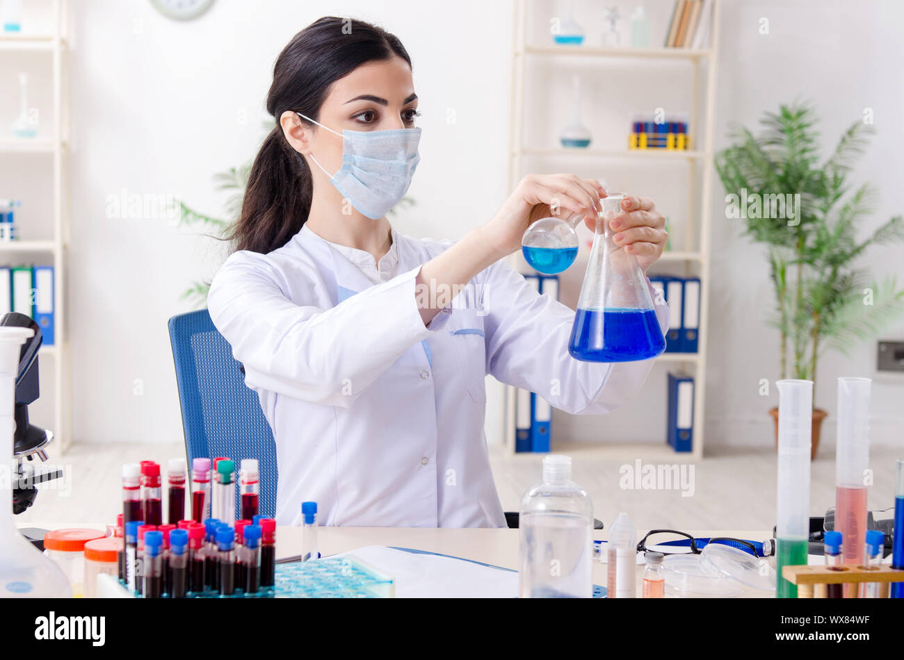 Female scientist mixing chemical solution hi-res stock photography and ...