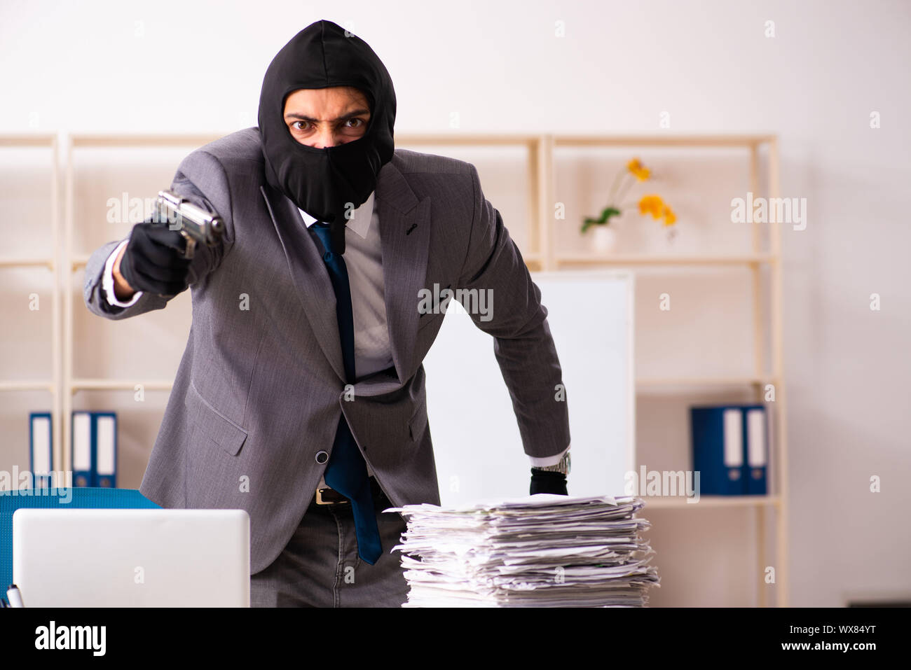 Male gangster stealing information from the office Stock Photo - Alamy
